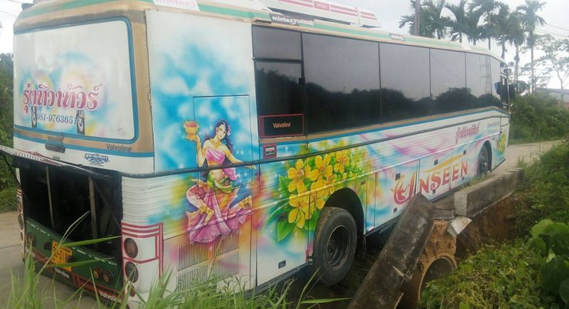 Tour bus stuck after road collapse
