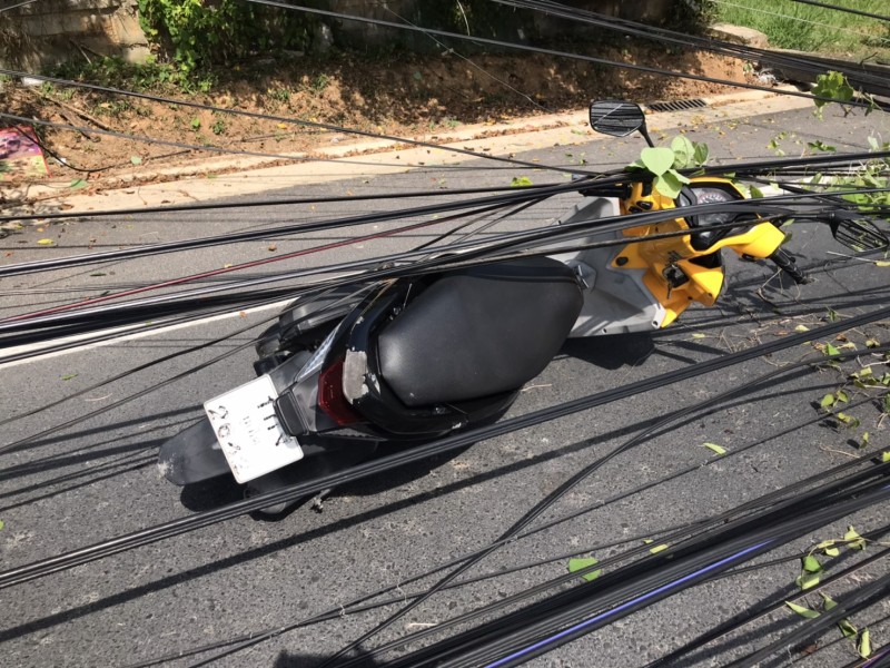 Narrow escape for motorbike rider as car hits power pole, brings down ...