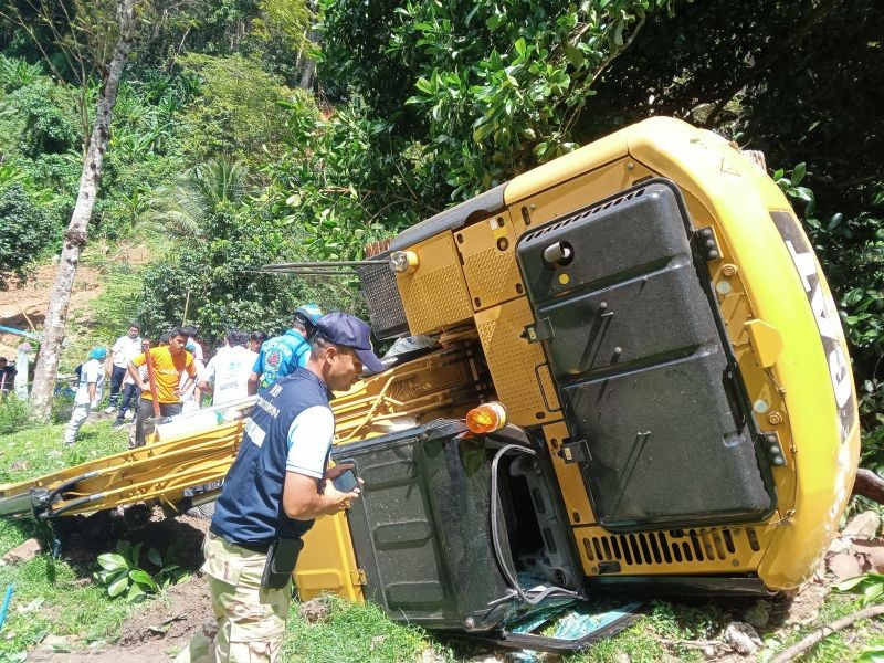 Driver rescued from overturned backhoe